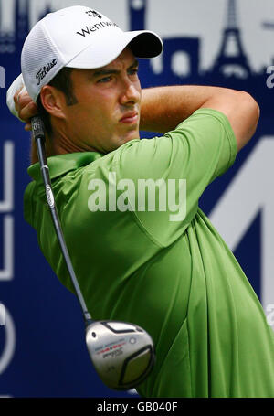 Ross Fisher, of England watches his tee shot on the seventh hole during ...