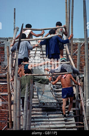 Building labourers manually lifting heavy concrete slabs, Chengdu ...