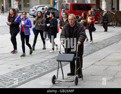 Old man with a zimmer walking frame Stock Photo - Alamy