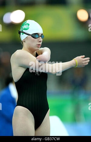 Female paralympic swimming athlete in dive position for swim race ...