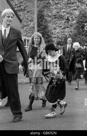 Dr Shaun Russell and daughter Josie walk away from the graveside after ...