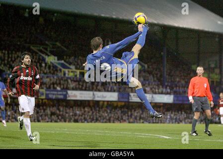 Portsmouth's Peter Crouch (right) has a shot early in the game Stock ...