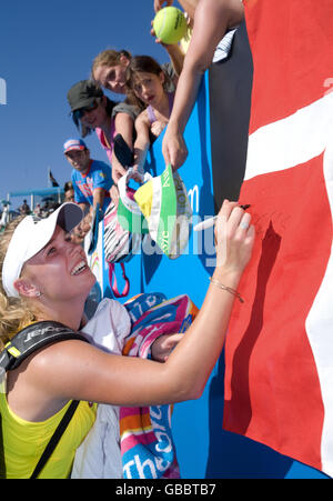 Caroline Wozniacki signs autographs for fans after winning her Ladies ...