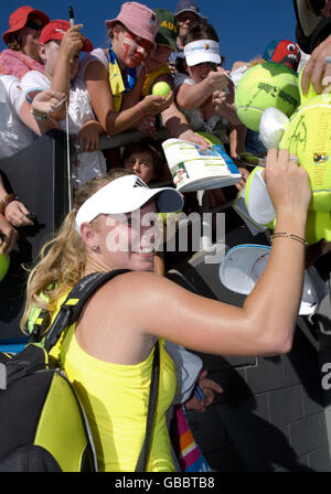 Caroline Wozniacki signs autographs for fans after winning her Ladies ...