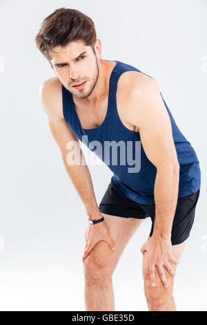 a young and handsome male athlete posing for a photo holding a shaker ...