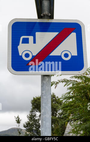 Blue sign showing lorry or HGV with red line through it to warn that ...