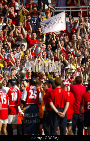 Arsenal fans celebrate with a banner saying 'immortal' Stock Photo - Alamy