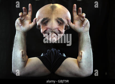 Australian performance artist Stelarc reflected in glass shows an extra ...