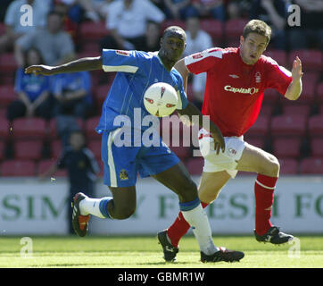 Wigan Athletic's Jason Roberts and Nottingham Forest's James Perch ...