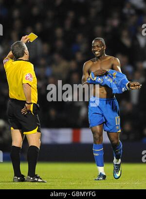 Referee Alan Wiley shows a yellow card to Manchester United's Cristiano ...