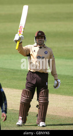 Surrey's Mark Ramprakash raises his bat to the pavilion to celebrate ...