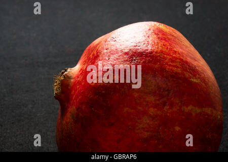 Big Pomegranate fruit on black background, closeup Stock Photo - Alamy