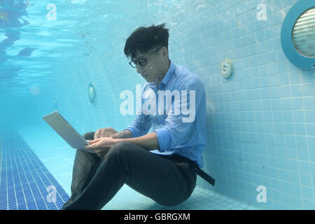 Business men use computers under water Stock Photo - Alamy