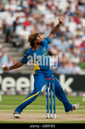 Sri Lankan bowler Lasith Malinga stretches his back during a practice ...