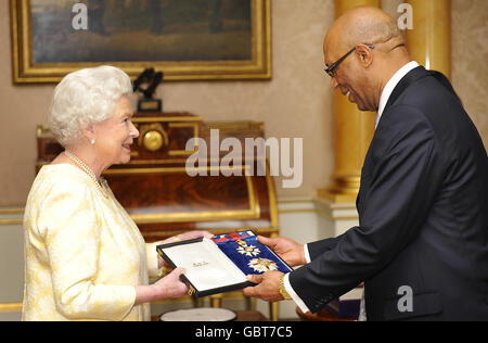 Queen Elizabeth II knights Sir Rodney Williams upon his appointment as ...
