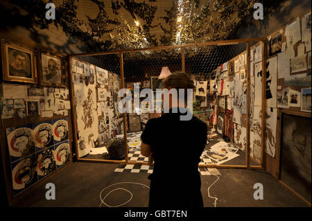 A woman stands in front of Banksy's fish tank mural. Members of the ...