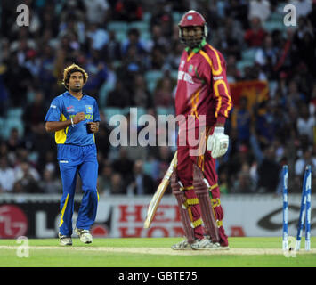 West Indies' Sulieman Benn (left) hits a boundary during the Second ...