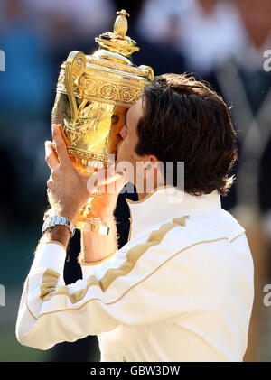 Switzerland's Roger Federer receives the trophy after beating USA's Andy Roddick to win the ...
