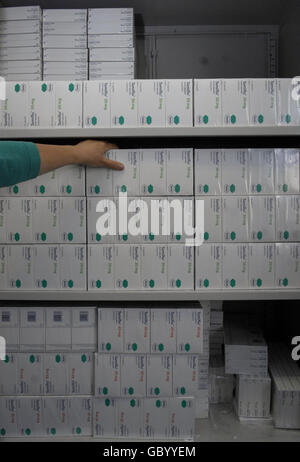 A member of staff at Mile End Hospital's anti-viral collection point ...