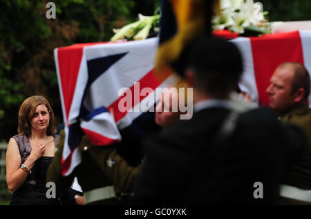 Karen Upton, the wife of Warrant Officer Sean Upton, is presented with ...