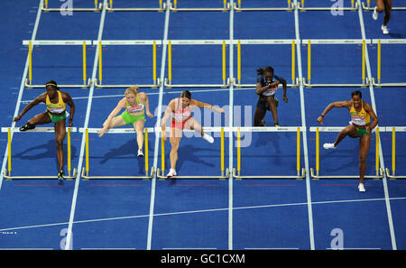 Jamaica's Brigitte Foster-Hylton, right, crosses the finish line to win ...