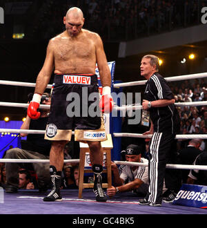 Russia's Nikolai Valuev stands his 7ft 2 inch tall as his cornerman ...