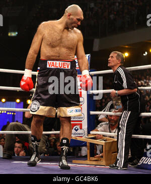 Russia's Nikolai Valuev stands his 7ft 2 inch tall as his cornerman ...