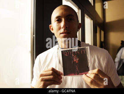 Fan Daniel Halawi, 25, from Essex, holds a copy of the new Michael ...