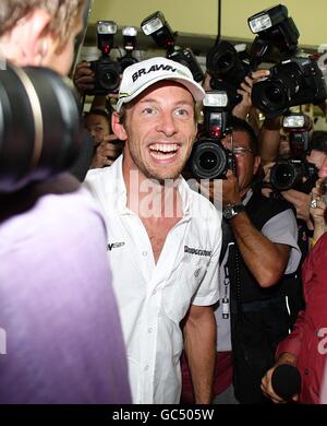 Brawn GP's Jenson Button (centre) takes a walk around the Interlagos ...
