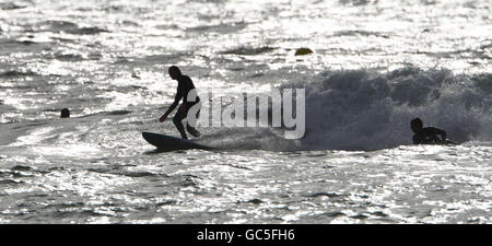 A surfer catches a wave generated from the new artificial surf reef ...