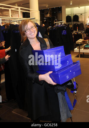 Shoppers snap up clothes and shoes during the Jimmy Choo for H&M launch ...