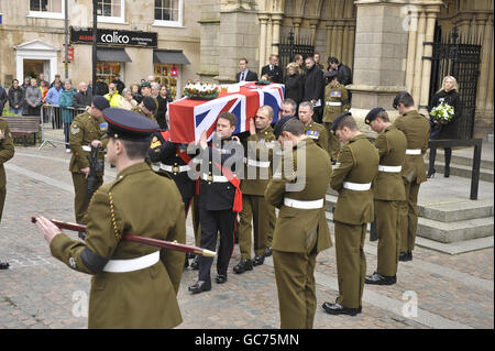 Christina Schmid (right) follows the coffin of her husband, Staff ...