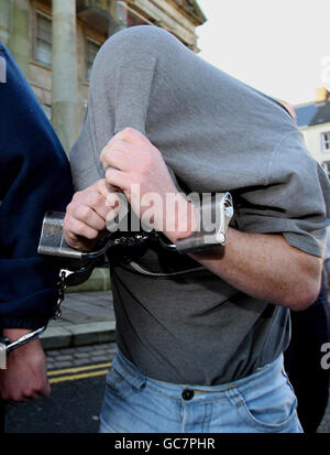 Barry Michael McCarney, 30, is led from Omagh Magistrates' Court, where ...