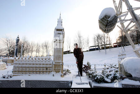 A worker cleans off snow in front of the Prague Castle after a heavy ...