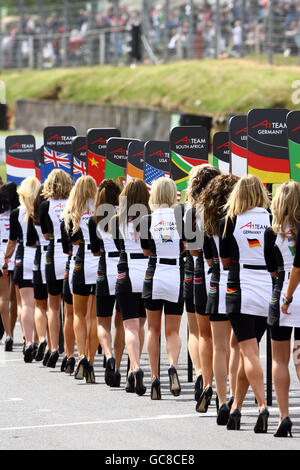 Grid girls line up holding the flags of the competing nations. on the ...