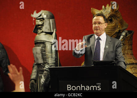 Bonhams auctioneer John Baddeley conducts a sale of props and costumes ...