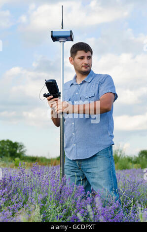 Land surveyor working in a lavender field and waiting for help Stock ...