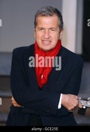 Fashion photographer Mario Testino poses with one of his cameras upon ...