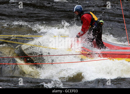 An emergency crew searches the water under the Wapiti River Bridge ...