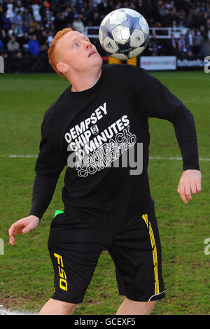 Football freestyler Dan Magness shows off his skills during half time ...