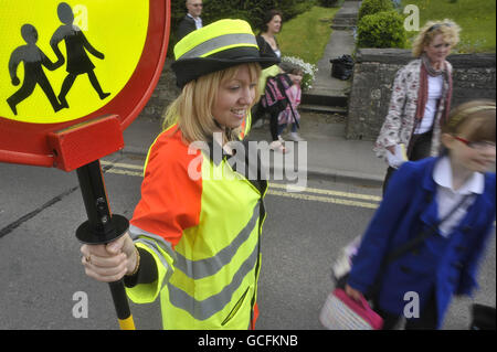 Lollipop Lady and school students crossing road England, UK Stock Photo ...