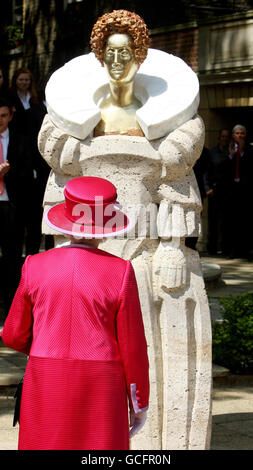 Britain's Queen Elizabeth II looks into the head of Albert Einstein ...
