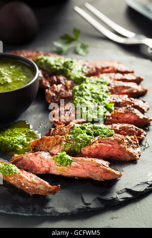 Grilled flank steak with chimichurri sauce on a grill pan Stock Photo ...