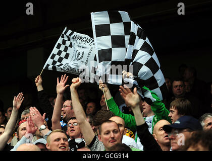 United fans wave flags in the crowd ahead of the Manchester United v ...