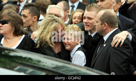 Nicola Hotine (centre), mother of Marine Anthony Hotine, 21, hugs her ...