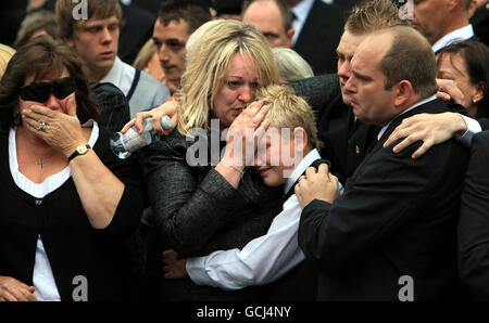 Nicola Hotine (centre), mother of Marine Anthony Hotine, 21, kisses her ...