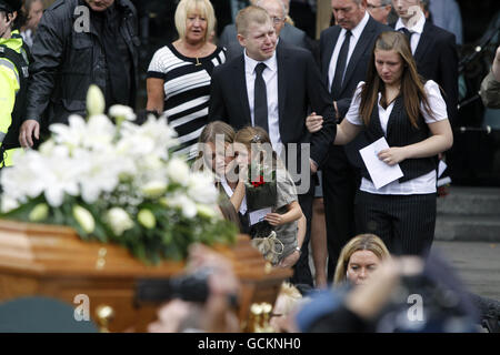 Mourners follow the coffin of Alex Higgins as it is carried from St ...