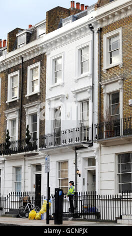 A PCSO stands outside a building where the body of an unnamed man was ...