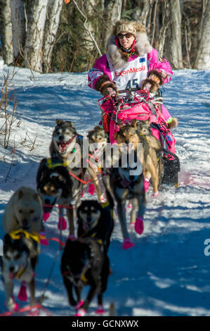 DeeDee Jonrowe and team run down the trail on Long Lake shortly after ...