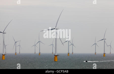 A small boat passes through the windmills of the Thanet Offshore Wind ...